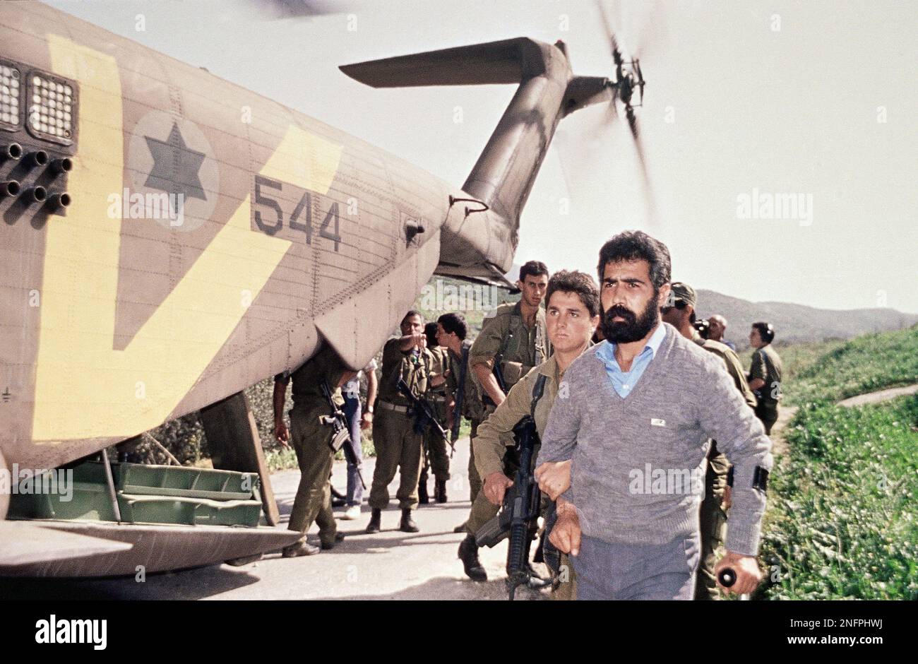 Abed el Aziz Uda Rafia is led by soldier away from helicopter which ...