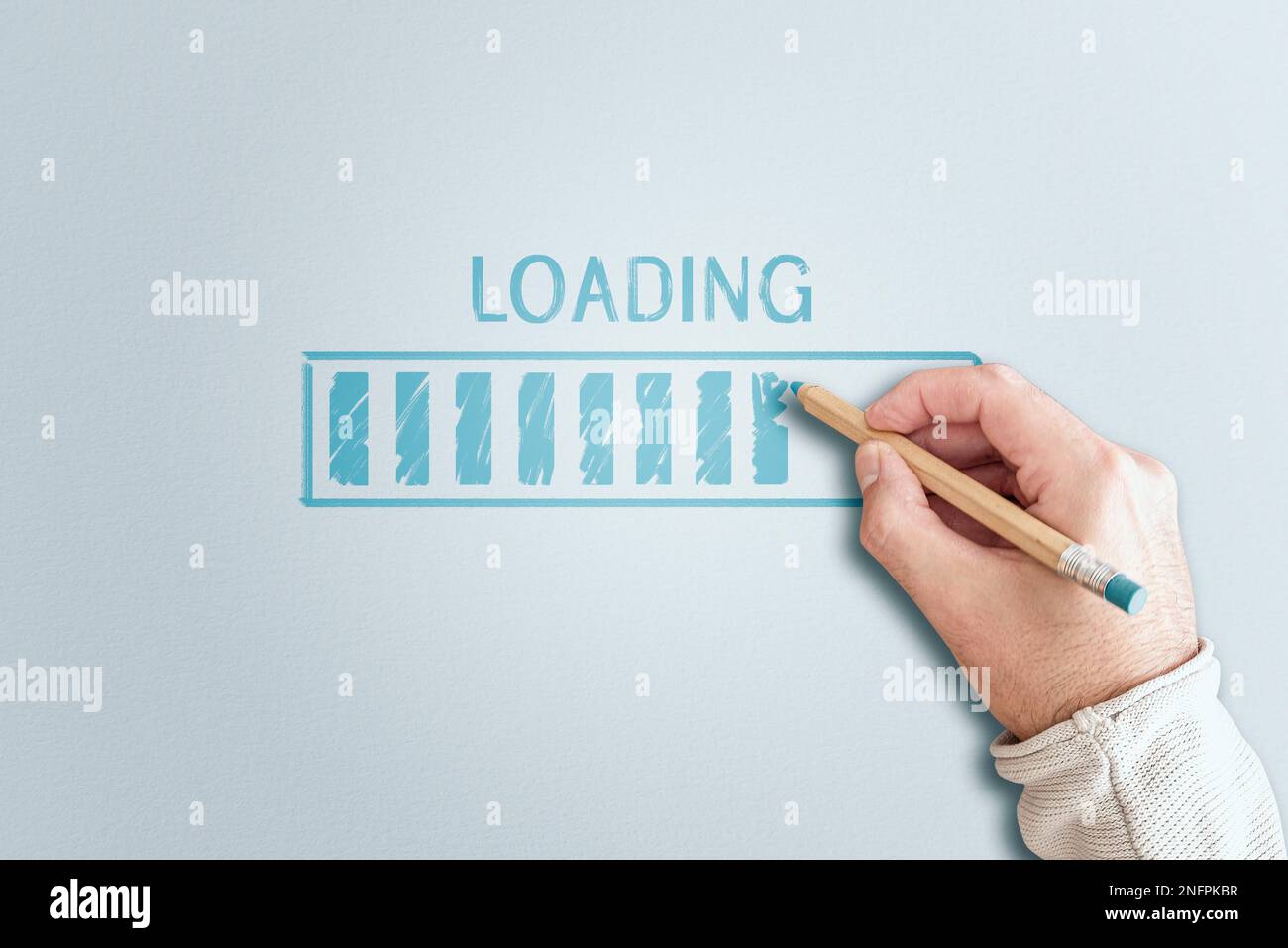 directly above shot of hand holding pencil drawing progress bar with ...