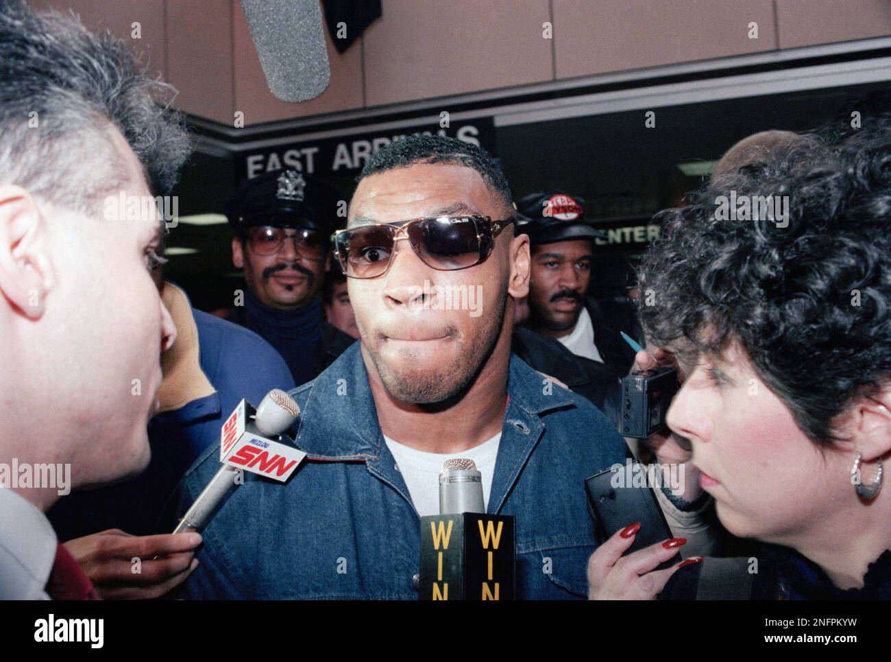 Former heavyweight Mike Tyson, wearing dark glasses covering a battered ...
