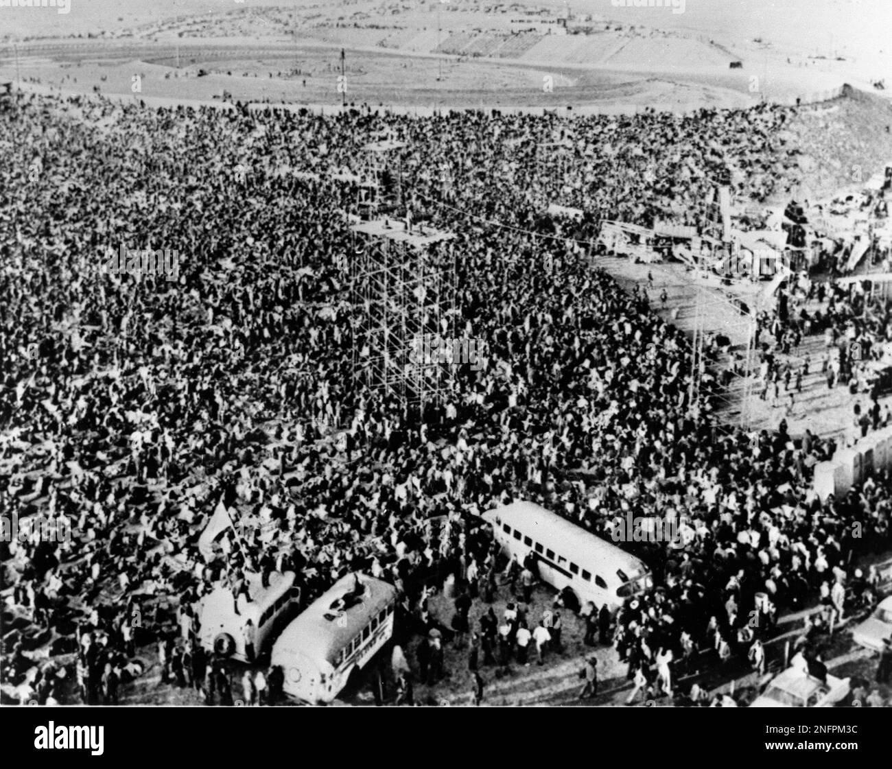 A large crowd of fans sits and waits at the Altamont Speedway, near ...