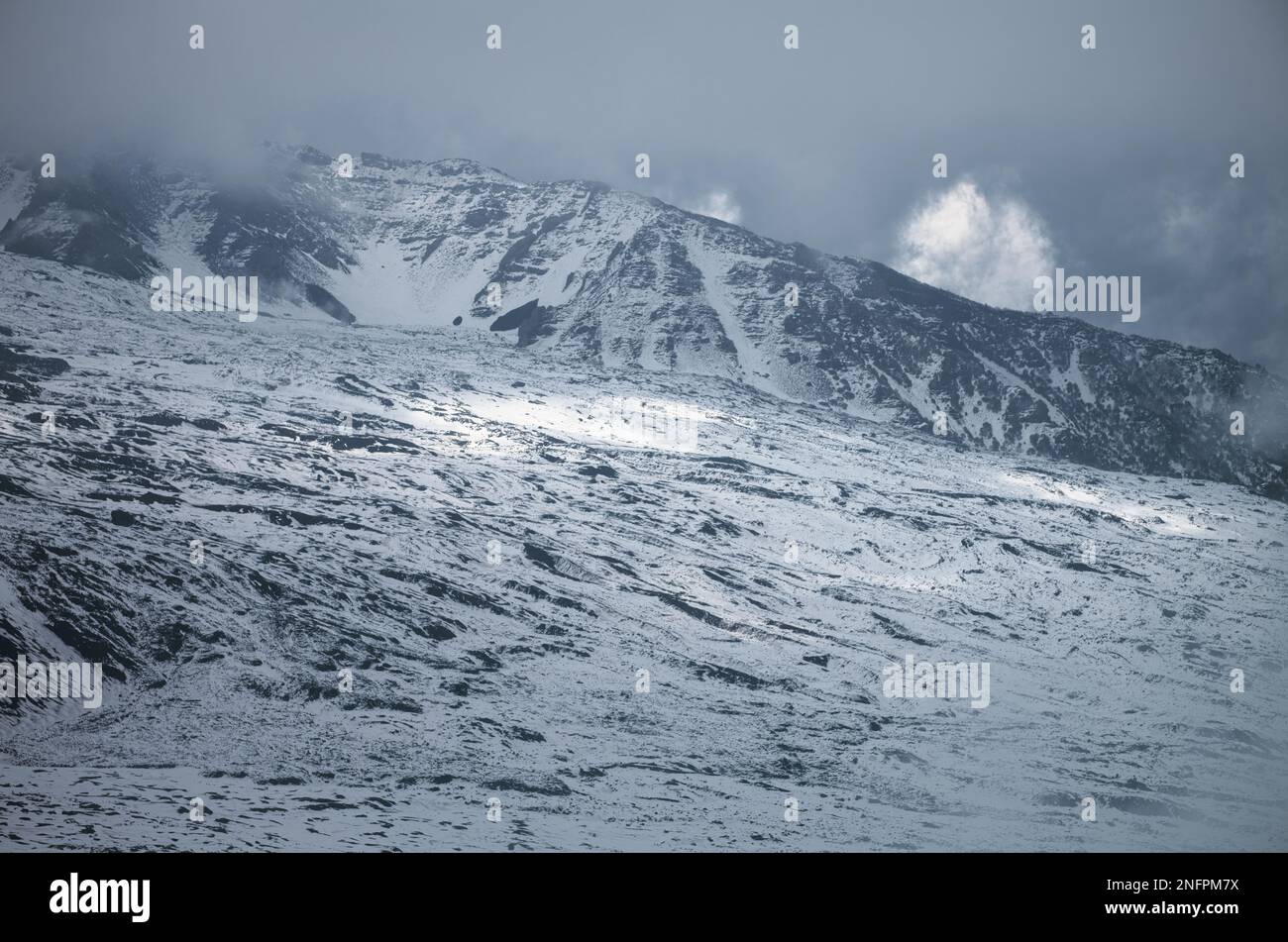the "Valle del Bove" snow covered and the mountain ridge of the "Serra ...