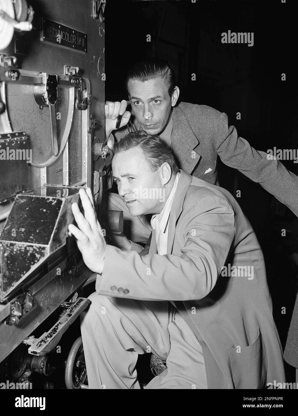 Henry Hathaway, director of the film "Nob Hill," checks his players ...
