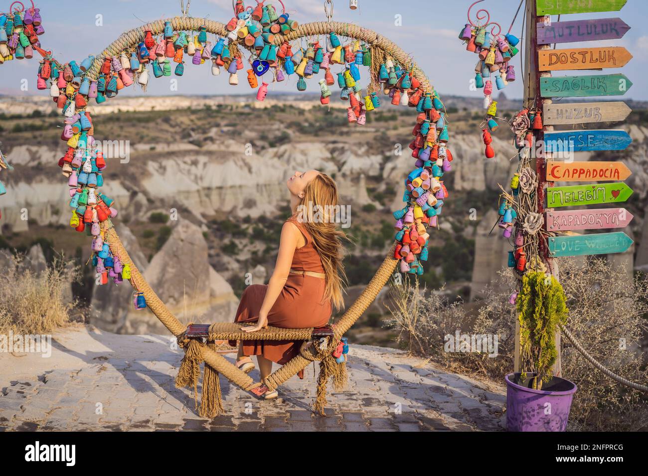 Young woman exploring valley with rock formations and fairy caves near ...