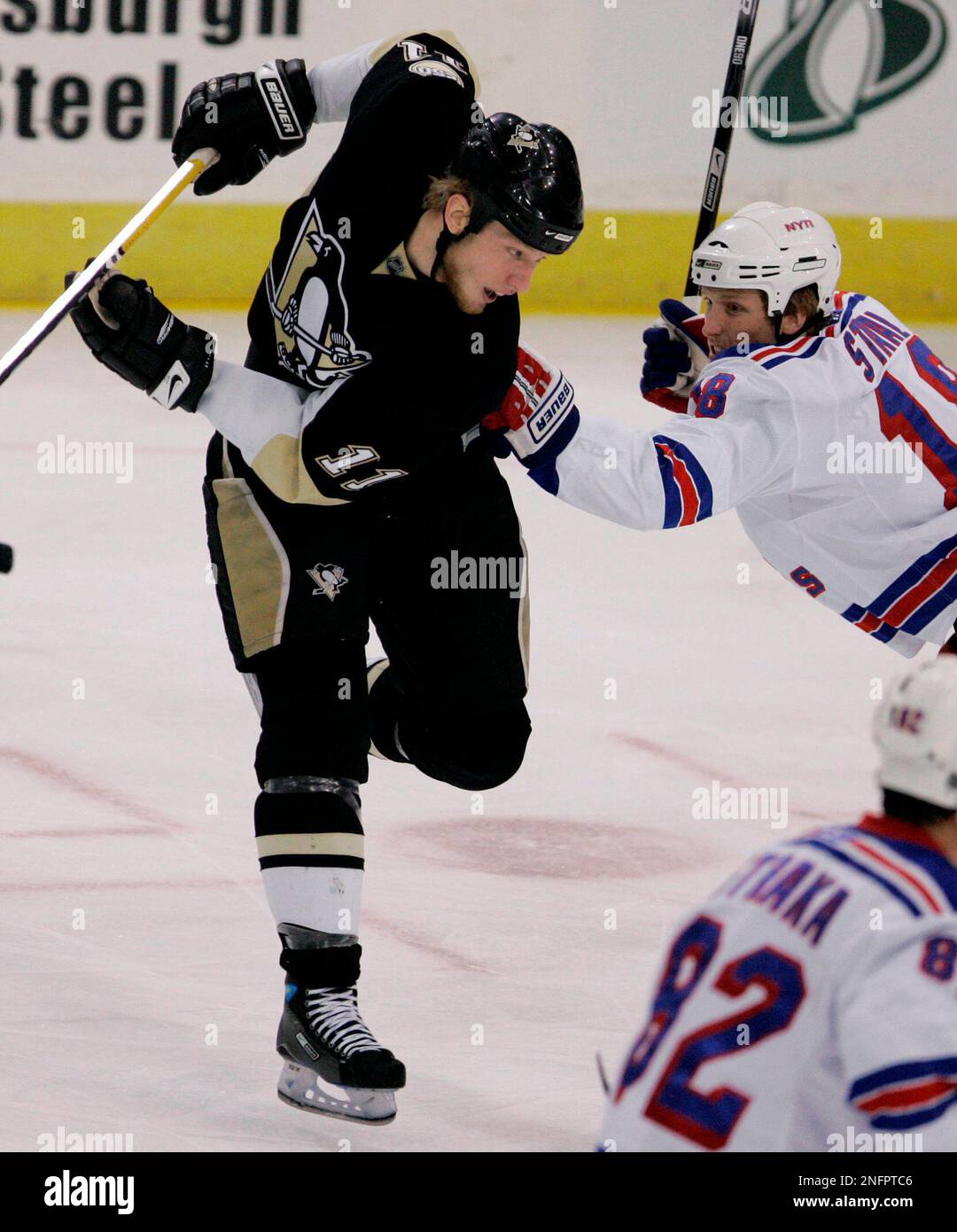 Pittsburgh Penguins' Jordan Staal (11) tries to get around his brother ...