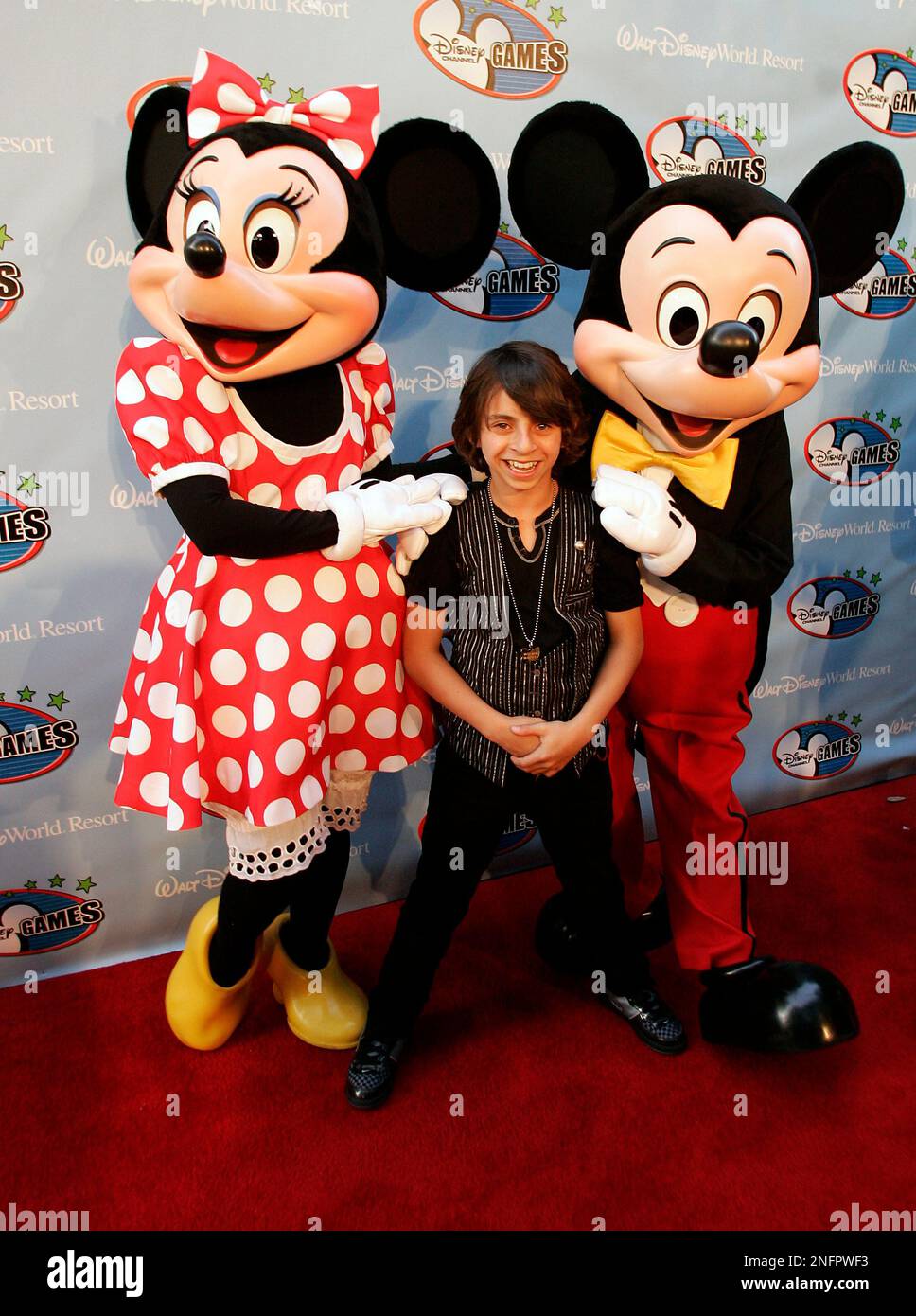 Moises Arias of "Hannah Montana" poses with Minnie and Mickey Mouse at ...