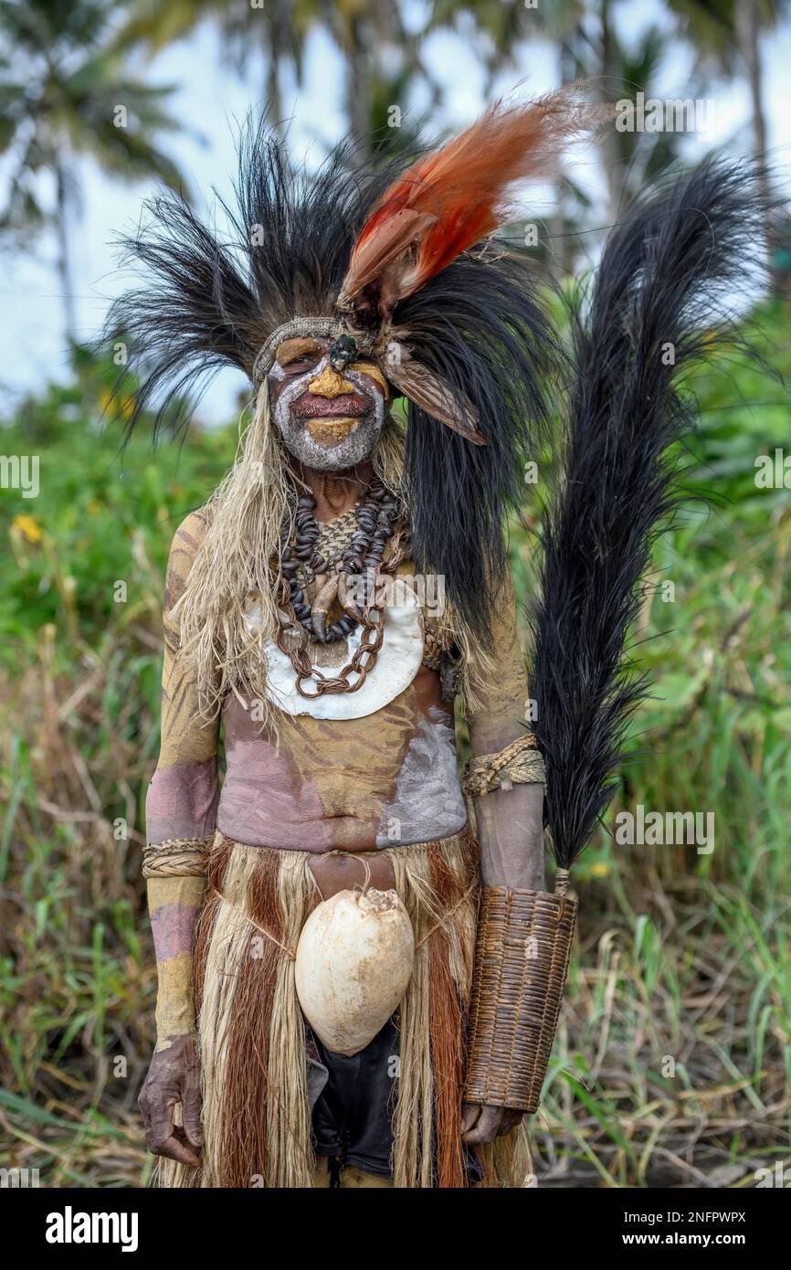Head of tribe decorated with cassowary feathers and a bird of paradise ...