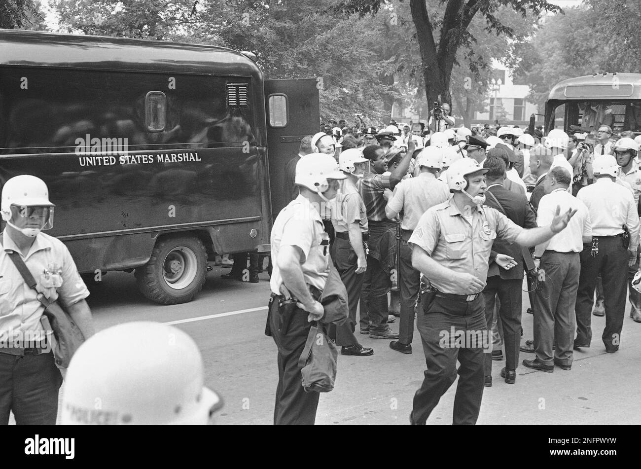 Civil rights leader Rev. Ralph Abernathy, background, with arm raised ...