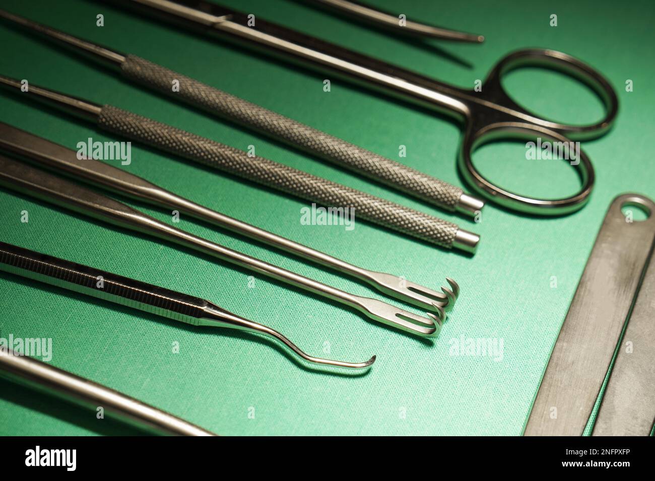 various surgical instruments on green hospital drape Stock Photo - Alamy