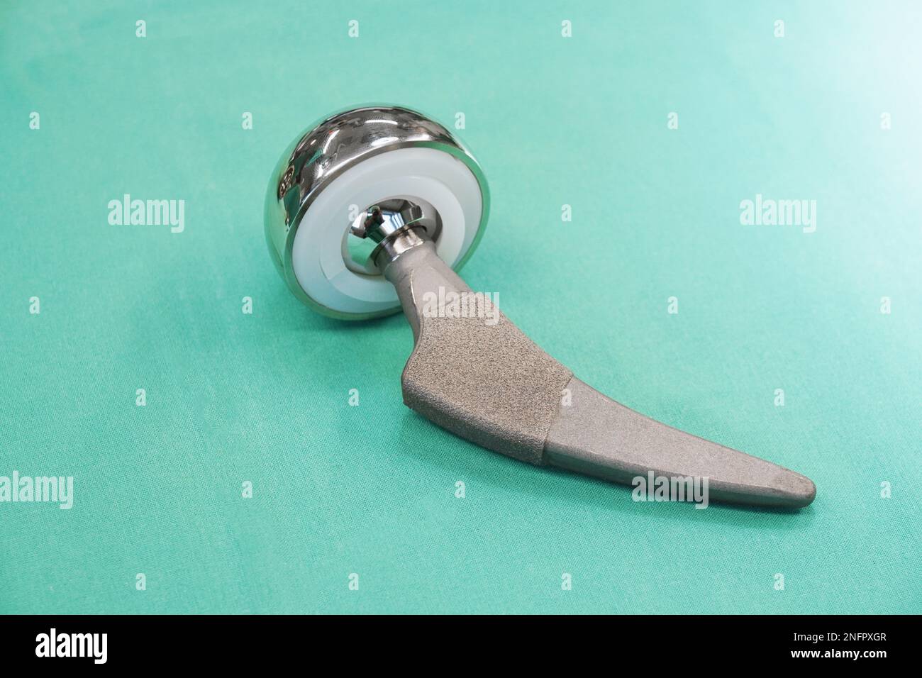 hip replacement prosthesis or prosthetic implant on green surgical ...