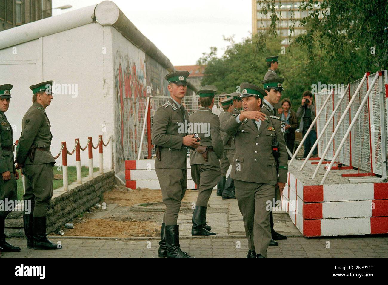 An East German border guard, seen Oct. 7, 1989, directs his troops ...