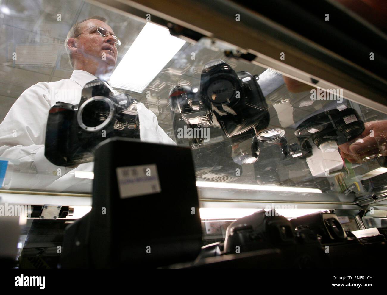 Jack Scadden, of Urbandale, Iowa, left, looks looks in a display case ...