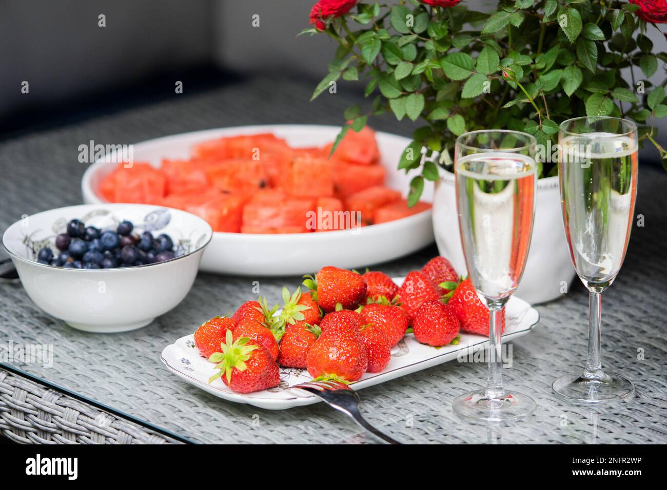Romantic dinner on the table with champagne, strawberries, blueberries ...