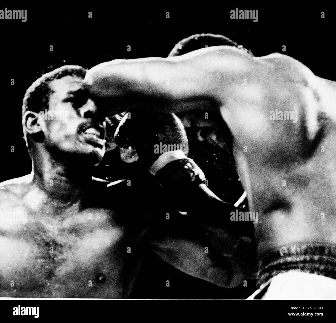 New IBF world heavyweight champ Michael Spinks, left, receives an elbow ...