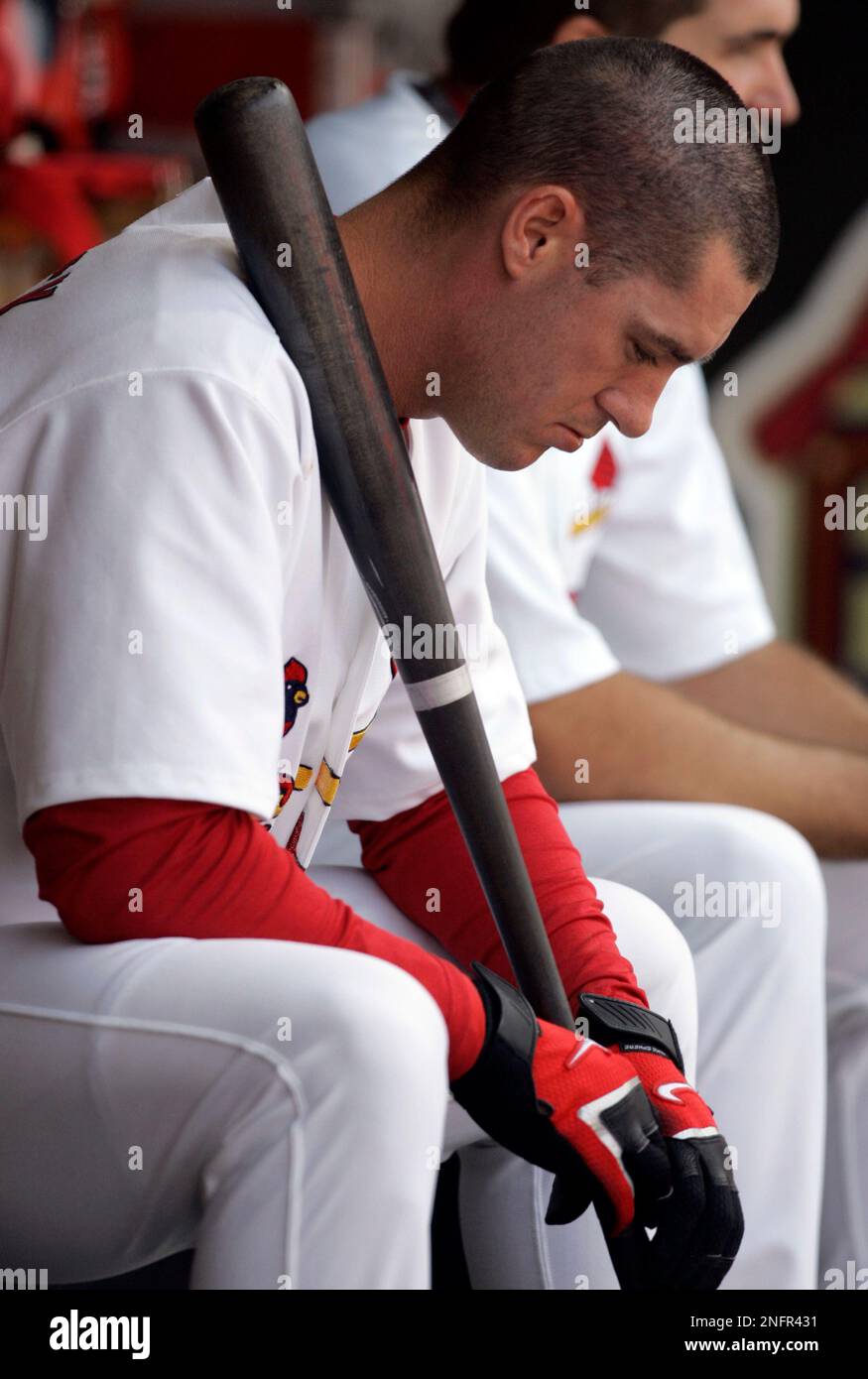 St. Louis Cardinals outfielder Ryan Ludwick sits on the bench with his ...