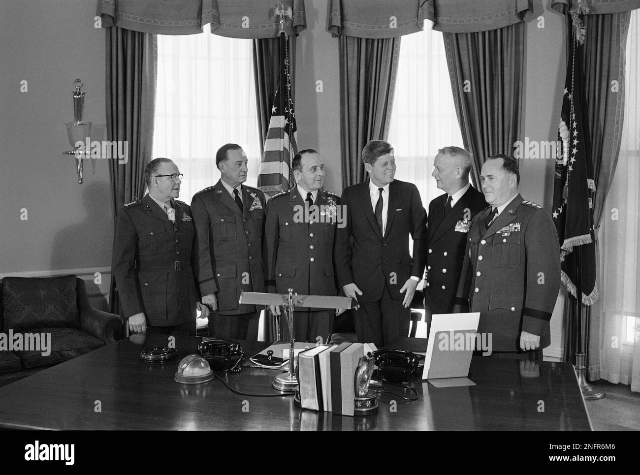 President John Kennedy poses in his White House office January 25, 1961 ...