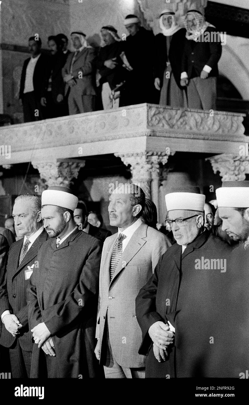 Egyptian President Anwar Sadat is accompanied by two unidentified ...