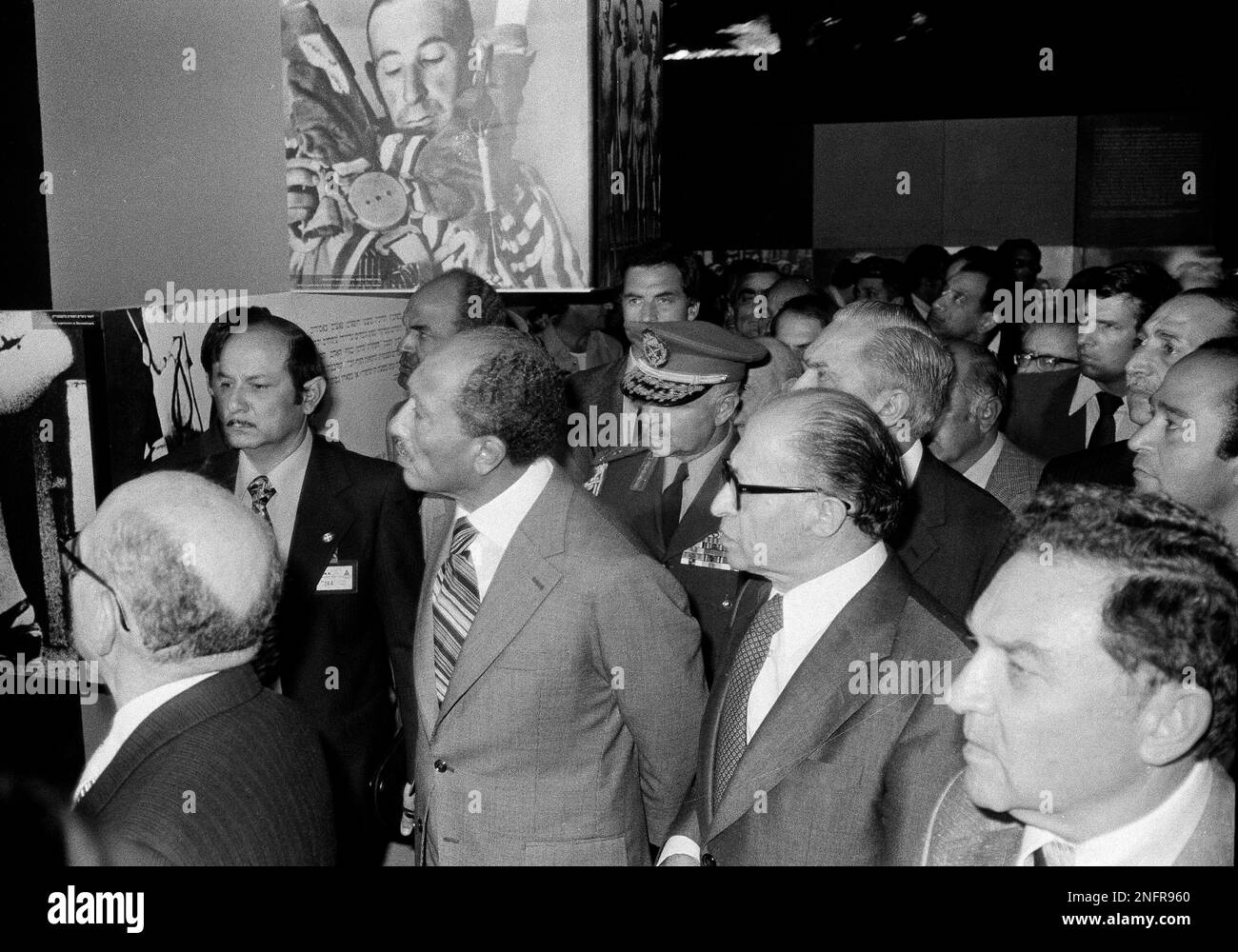 Egyptian President Anwar Sadat, center, looks at photographs in the Yad ...