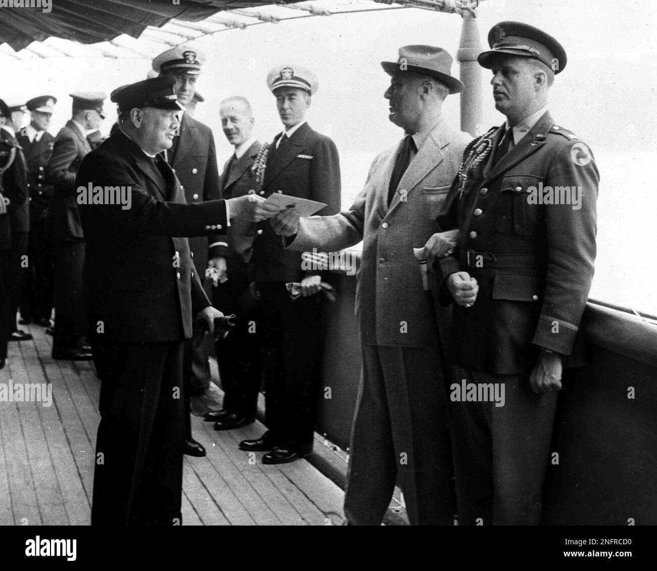 Britain's Prime Minister Winston Churchill, left, hands over a personal ...