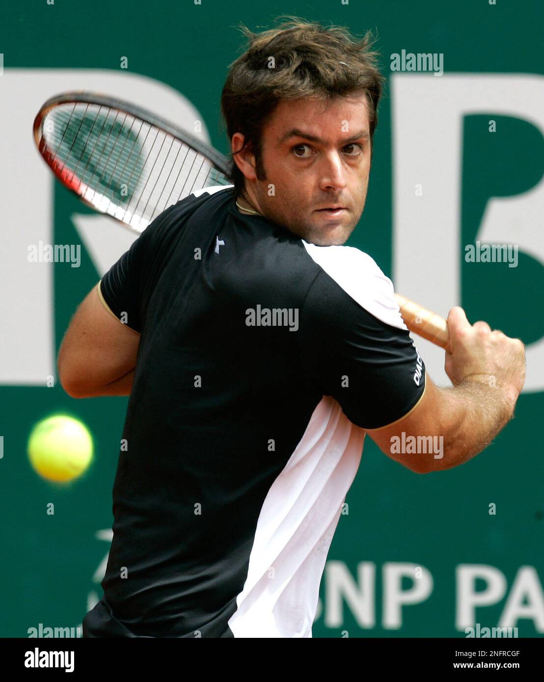 Augustin Calleri of Argentina prepares to return the ball to Andreas ...