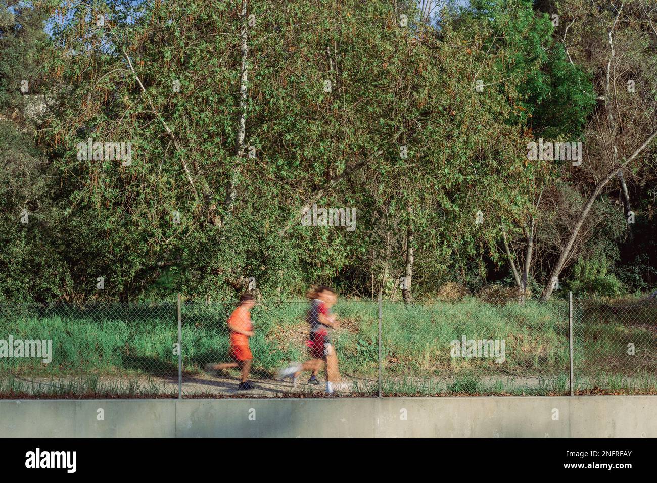 Children playing behind a fence hi-res stock photography and images - Alamy