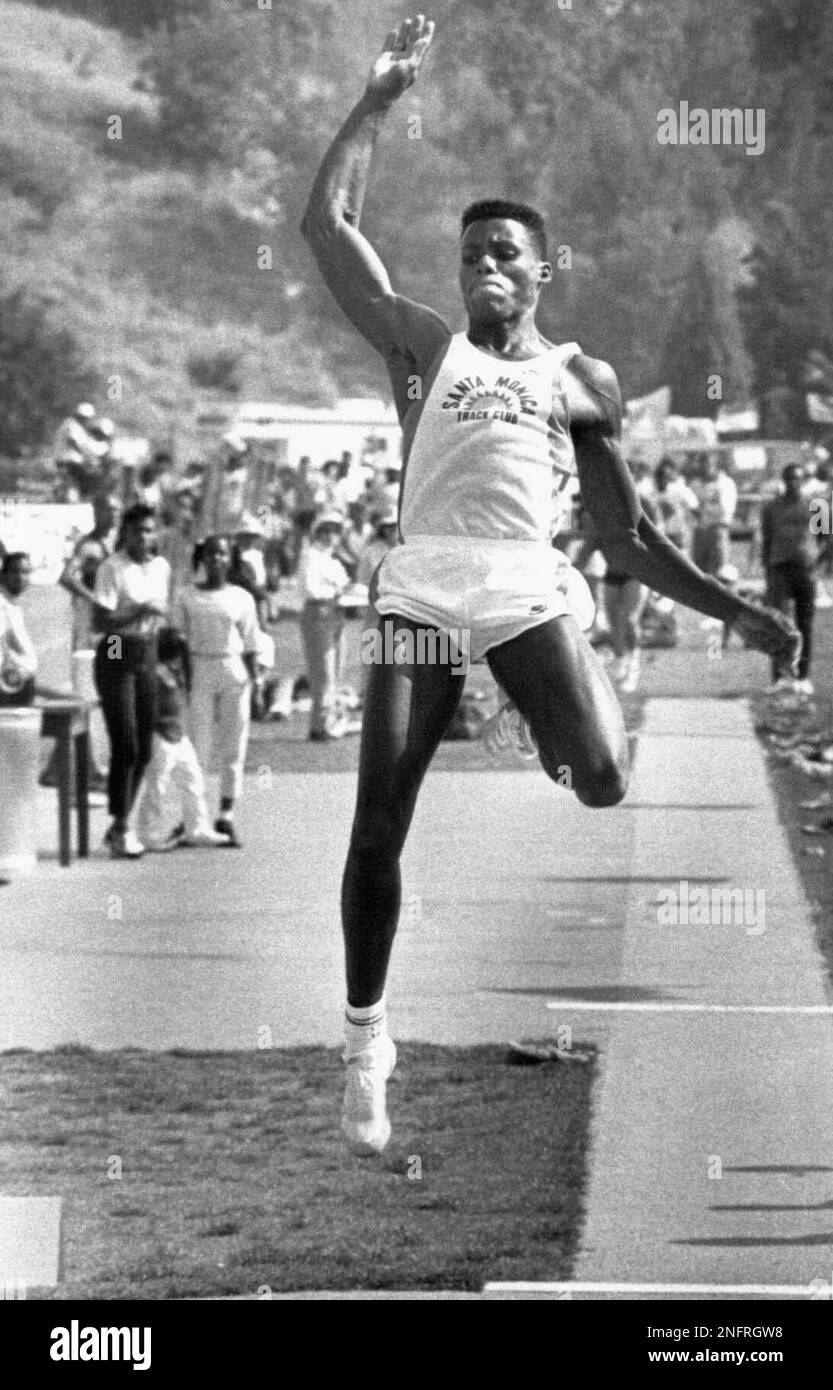 Track hero Carl Lewis completes the men's invitational long jump in 28. ...