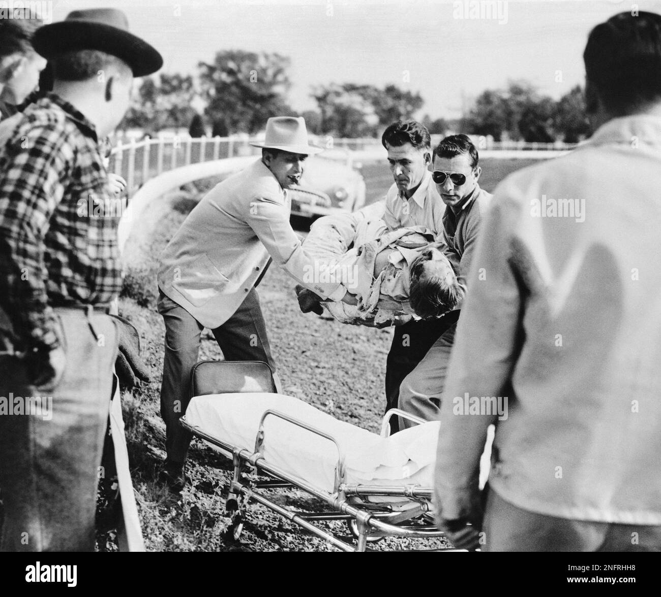 Ted Horn, 38-year-old racing car driver, is lifted from the Du Quoin ...