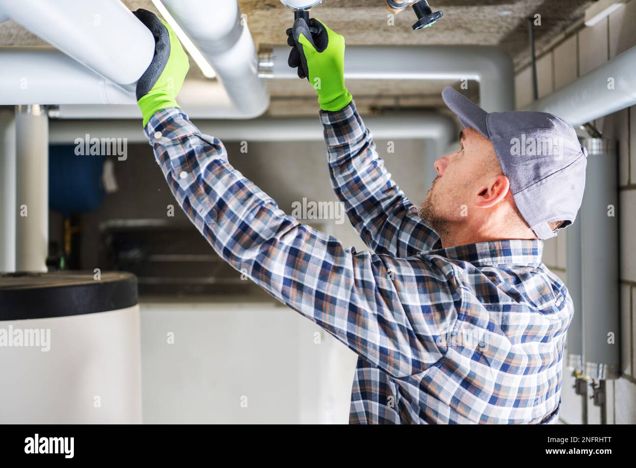 Professional Plumber Checking Water Valves in the Pipes of the ...