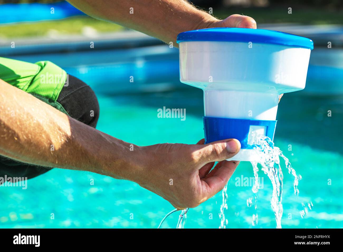 Closeup of Floating Chemical Dispenser in Hands of Professional ...