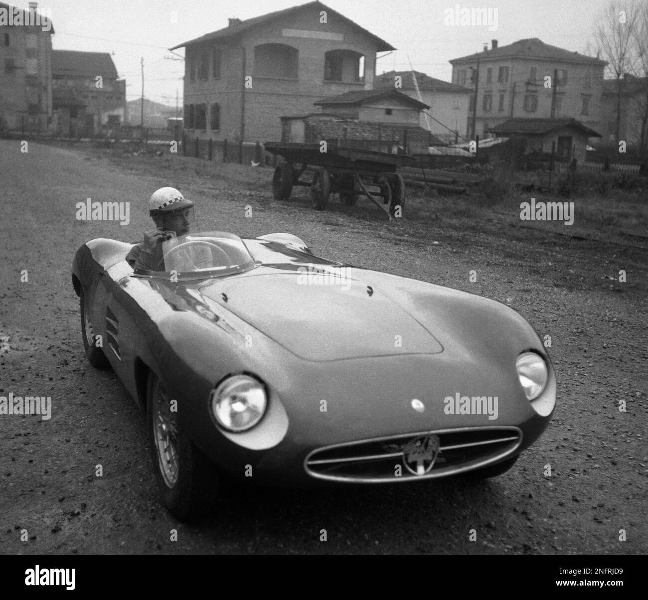 French driver Jean Behra sits in a new Maserati 300s race car at Modena ...