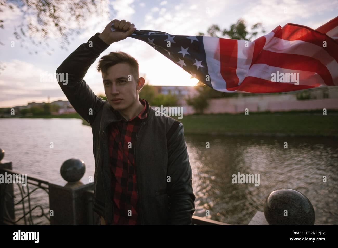 Guy with US flag flying on wind Stock Photo - Alamy