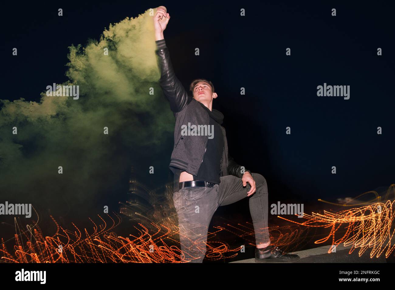 Crazy male fan with smoke bomb at night Stock Photo - Alamy
