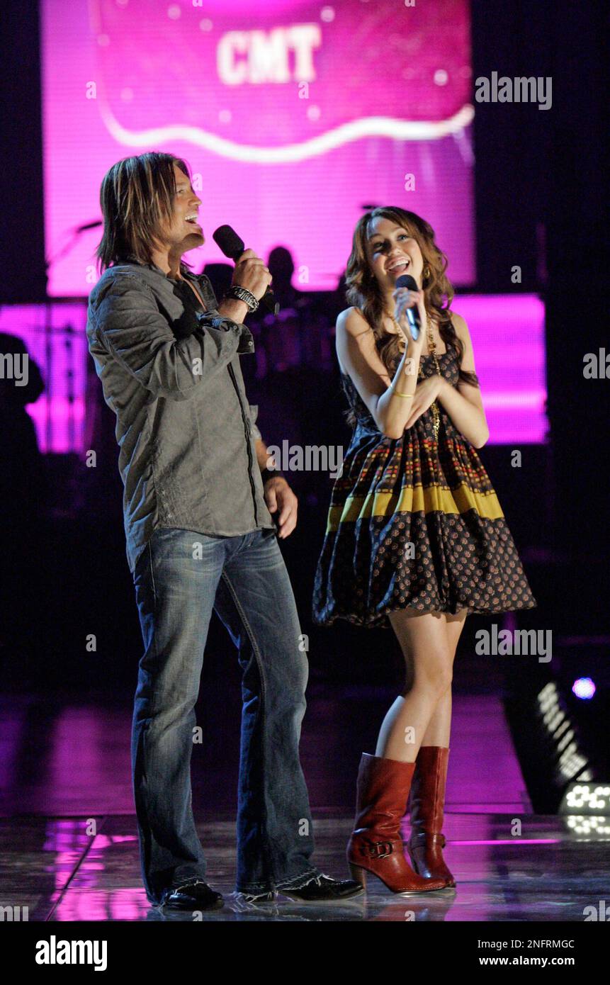 Hosts Billy Ray Cyrus and his daughter, Miley Cyrus on stage during the ...