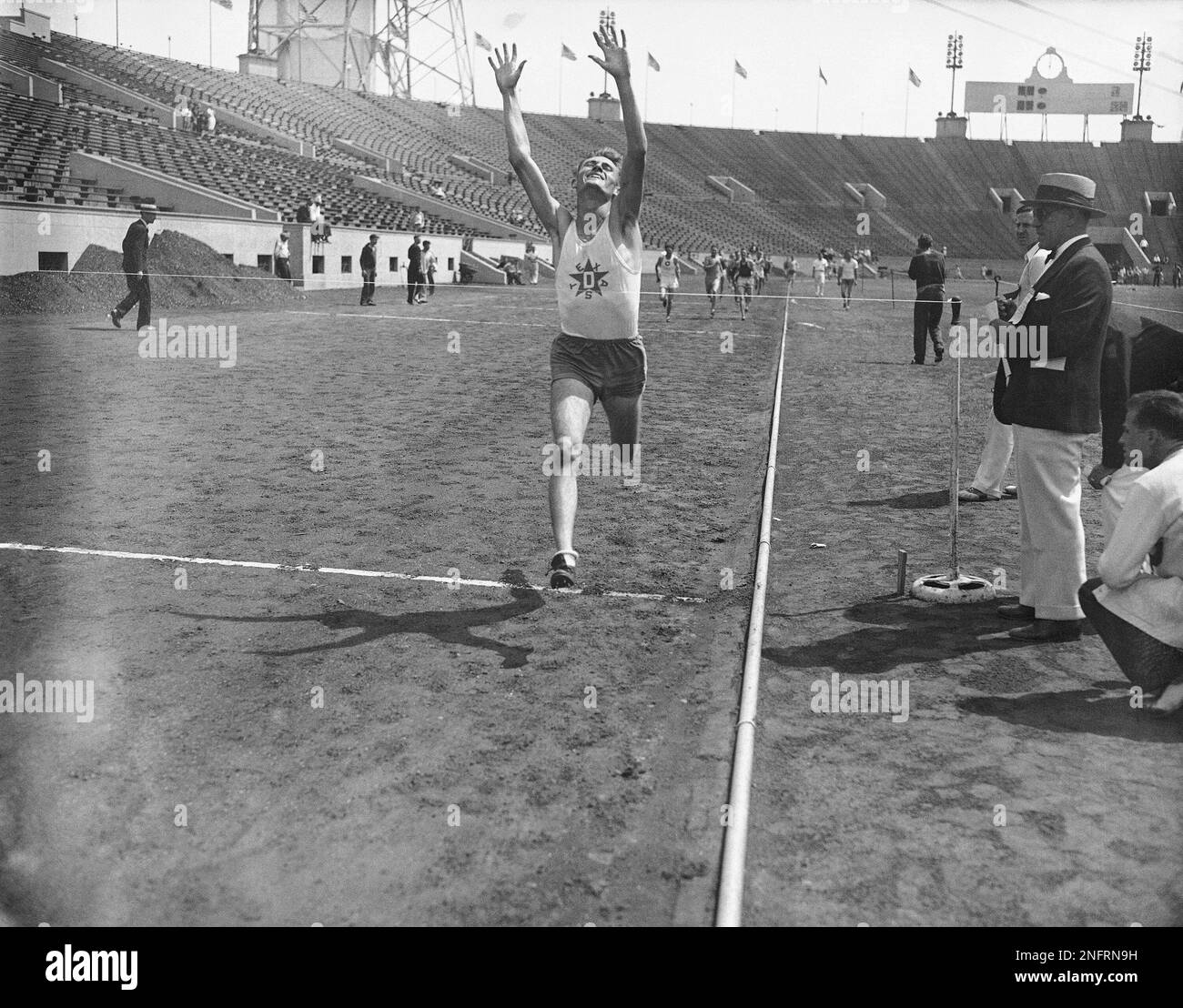 Ross Bush of Sunset High School in Dallas, Tex., crosses the tape in ...
