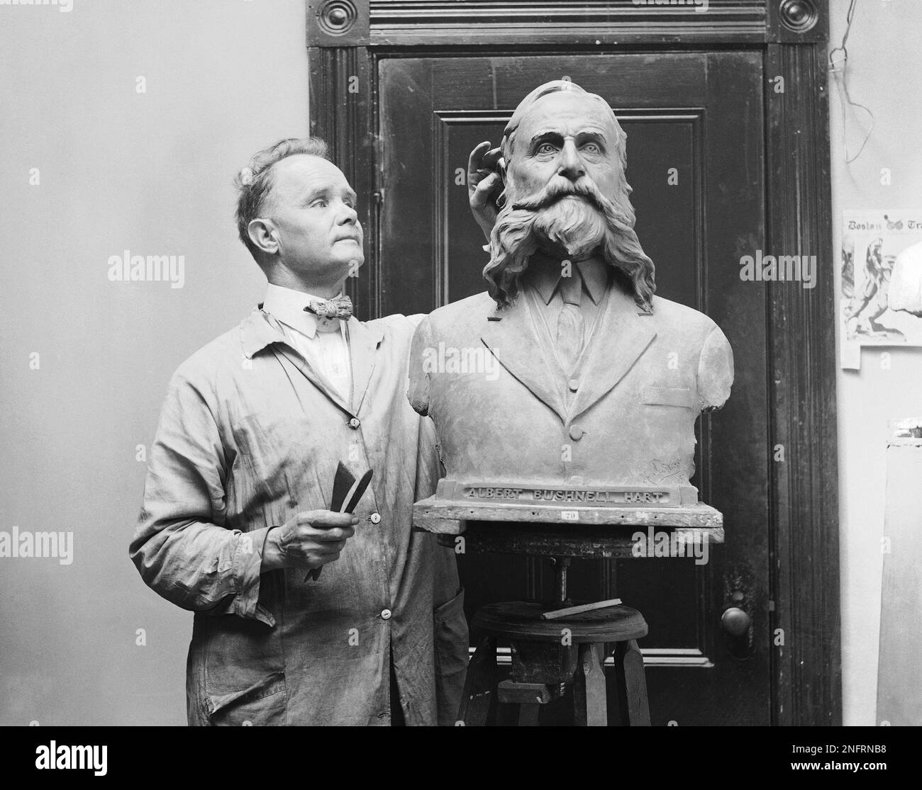 Karl F. Skoog, Boston sculptor, touches up a bust of the oldest Harvard ...