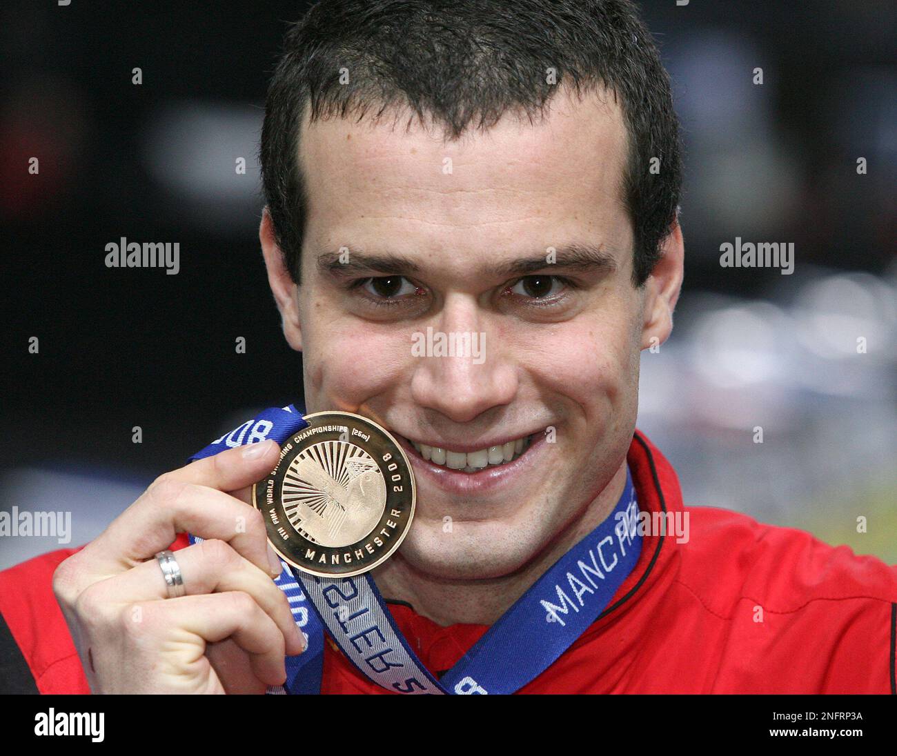 Austria's Markus Rogan smiles as he poses with the gold medal he won in ...
