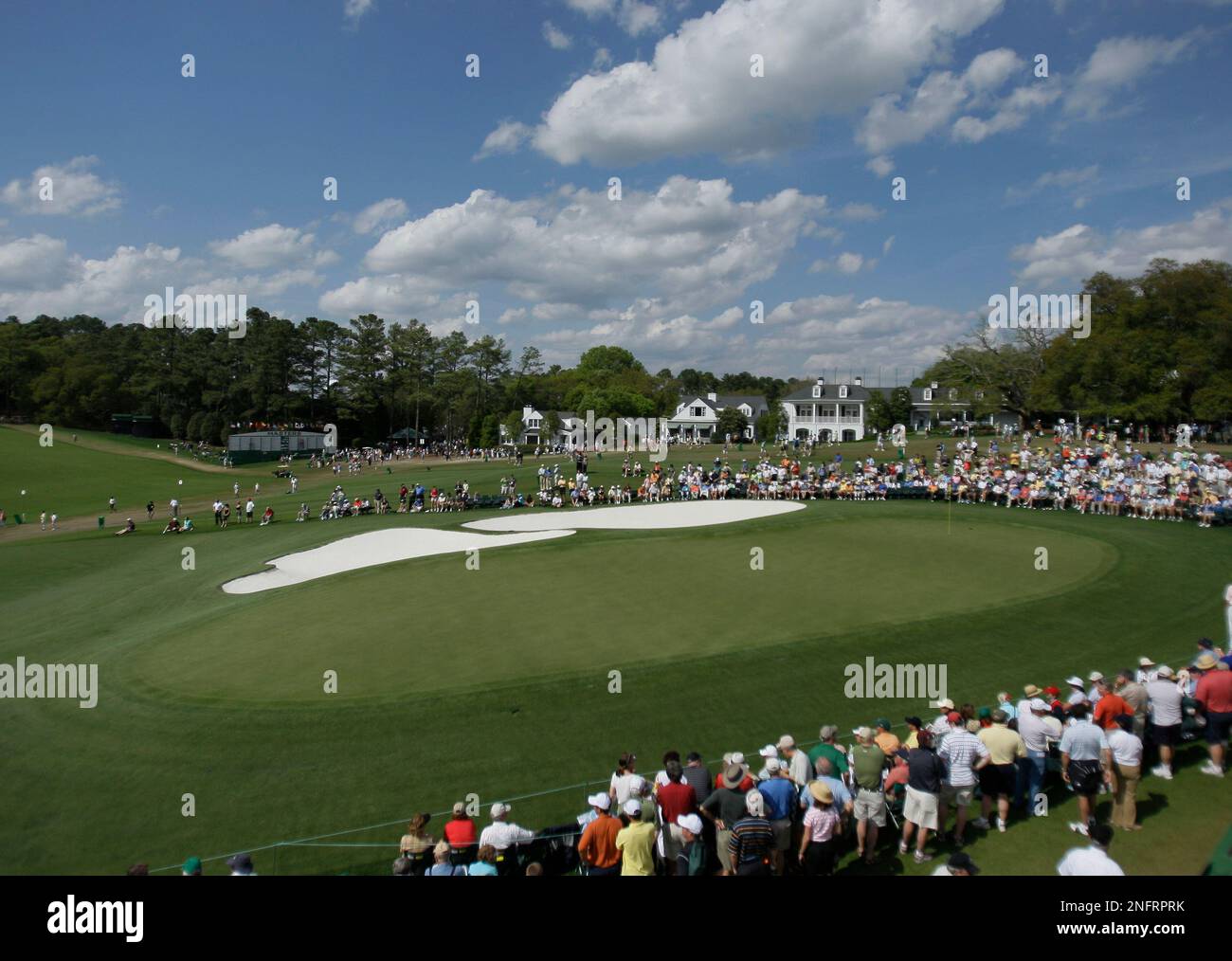 Patrons wait for golfers around the ninth hole during the second round ...