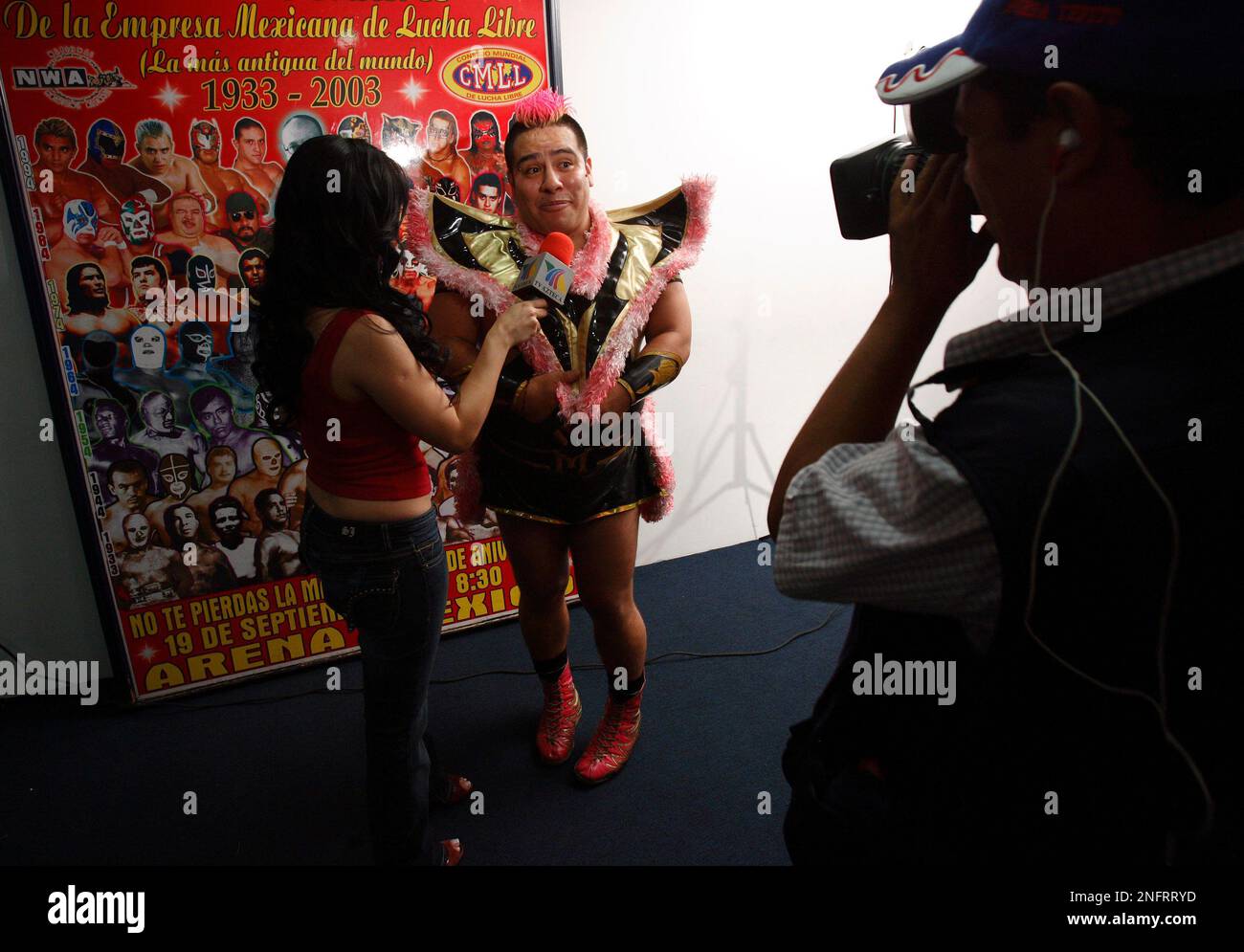 The wrestler Maximo speaks with a television reporter in a backroom ...