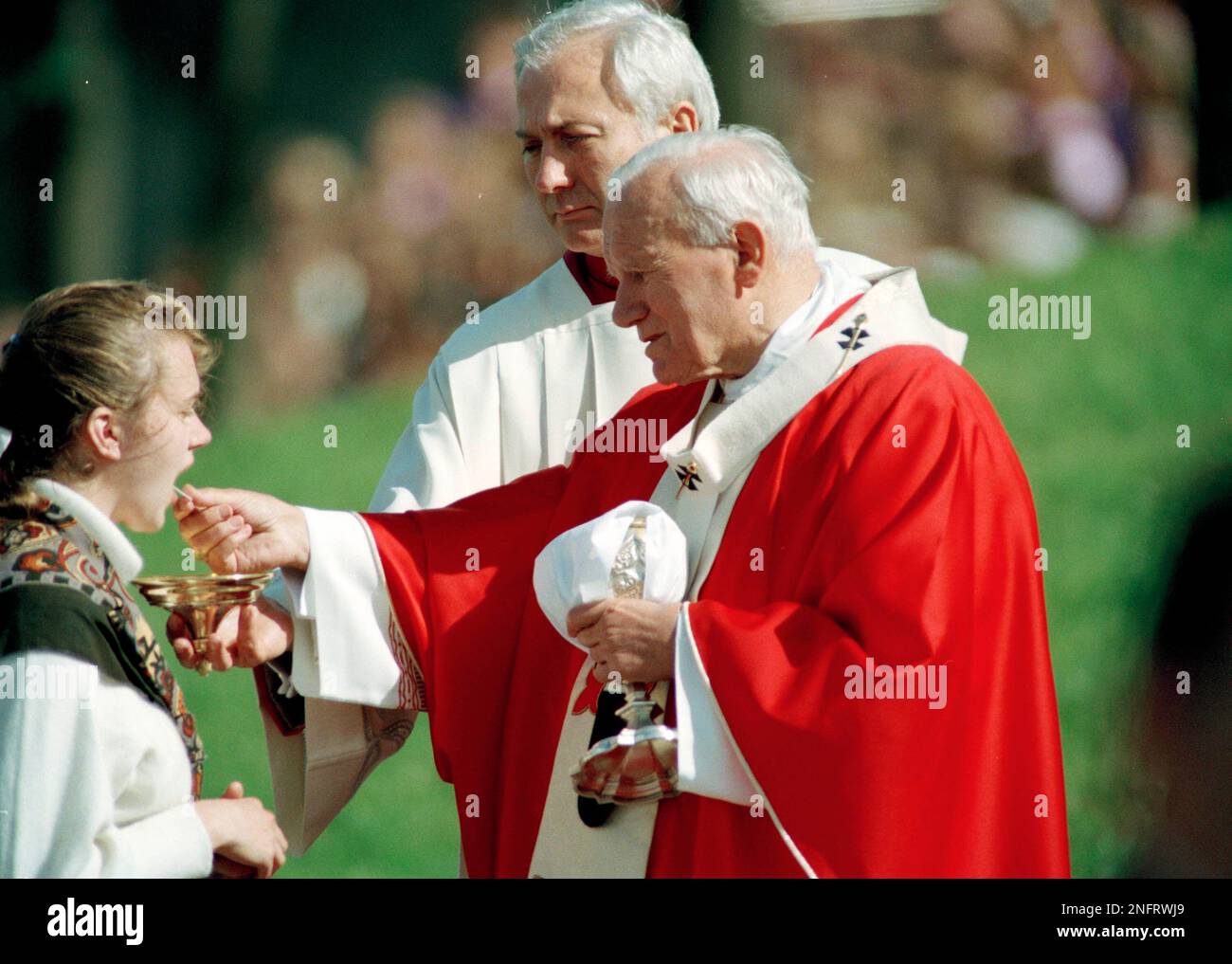 Pope John Paul II gives Holy Communion to a young Lithuanian girl ...