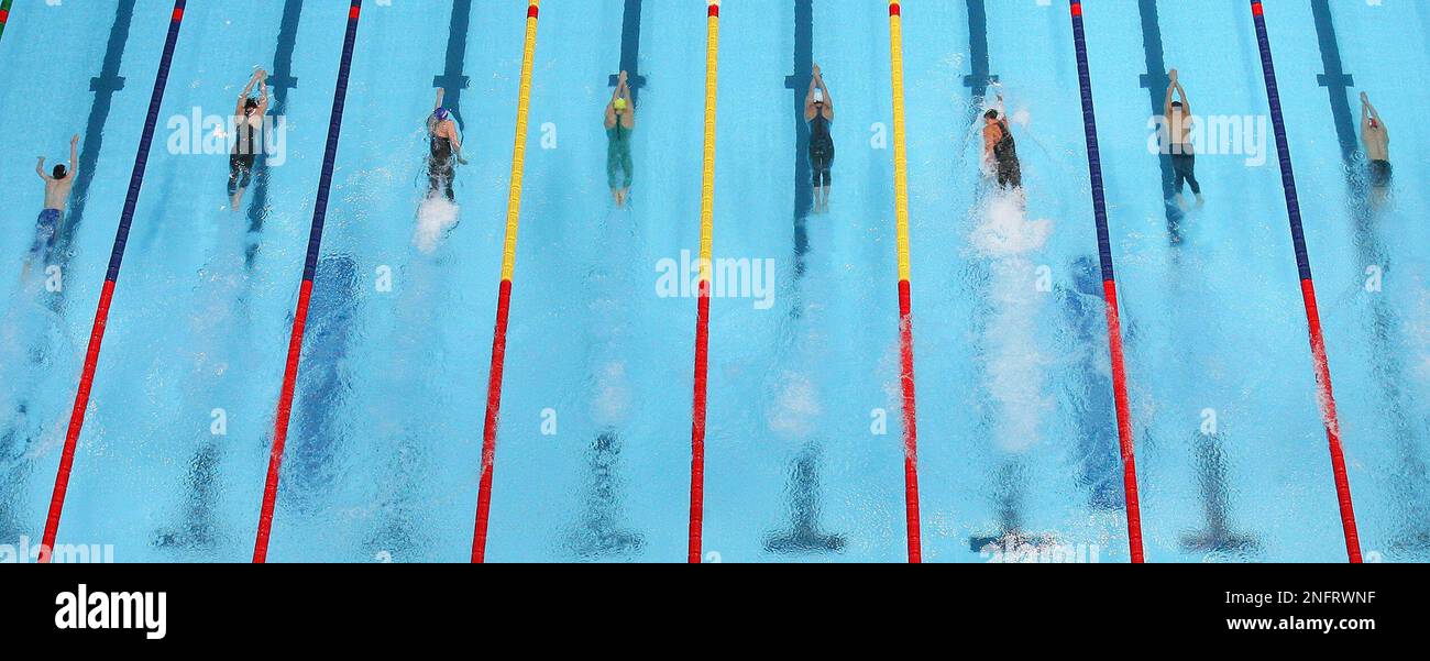 Swimmers start a Men's 4x100m freestyle relay heat during the World ...