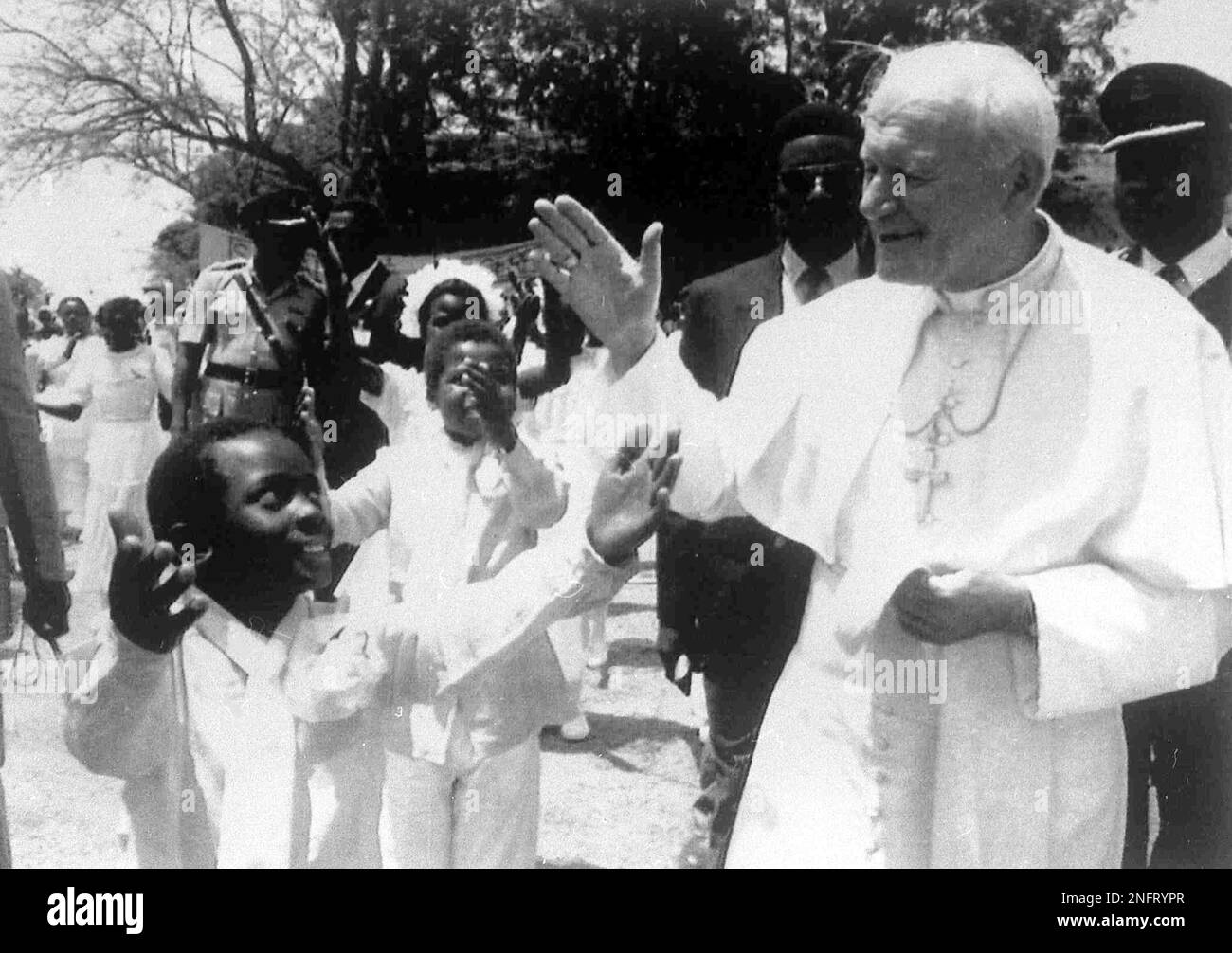 Pope John Paul II blesses a gesturing boy before an open air ceremony ...