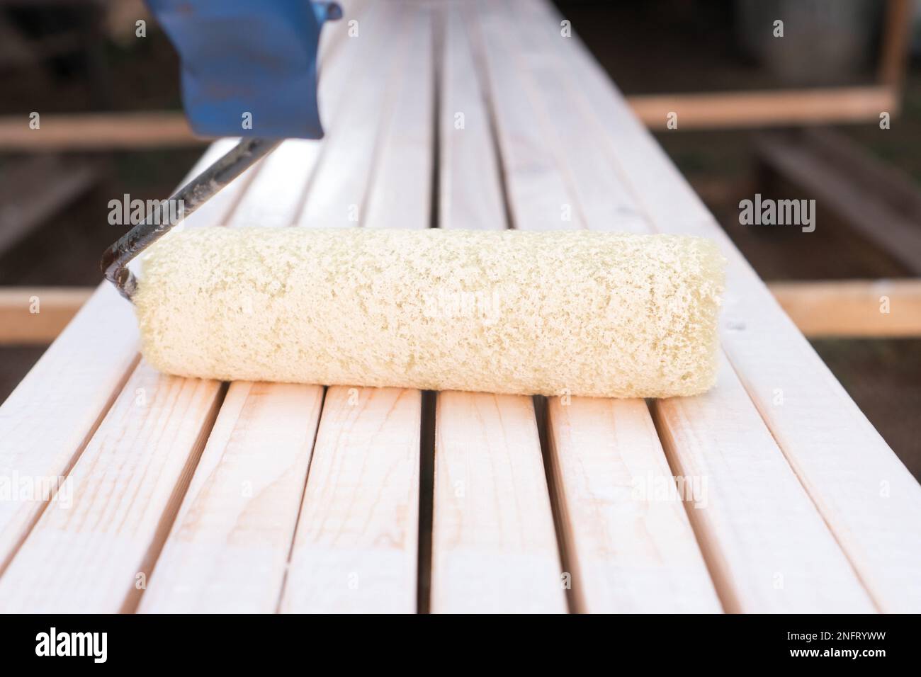 Close up white soft professional paint roller applicator with handle ...