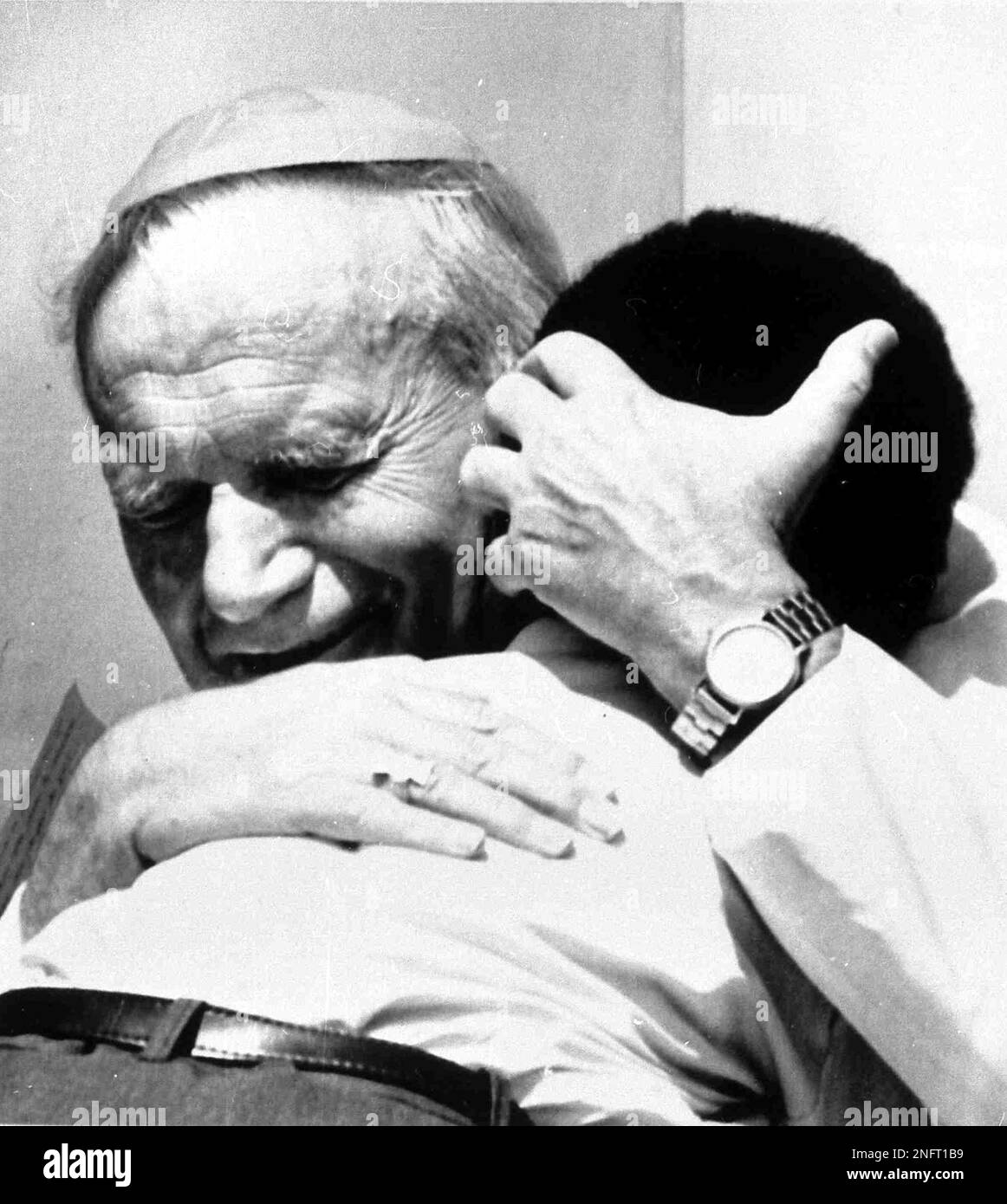 Pope John Paul II hugs a young Mauritius child Monday, Oct. 16, 1989 ...