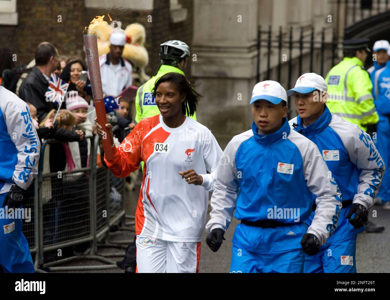 Olympic torch bearer Denise Lewis runs up No.10 Downing street during ...