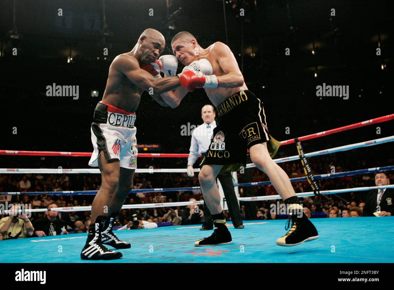Joel Casamayor, left, locks up with Jose Armando Santa Cruz during the ...