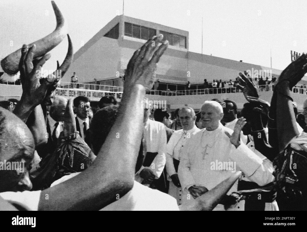 Pope John Paul II is welcomed by African dancers in the central Angolan ...