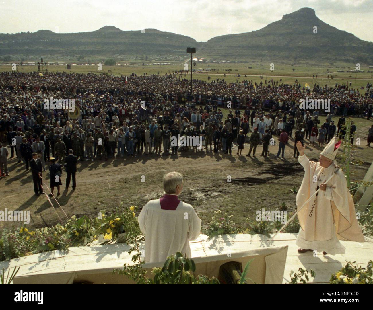 Pope John Paul II greets some 10,000 believers from the stage erected ...