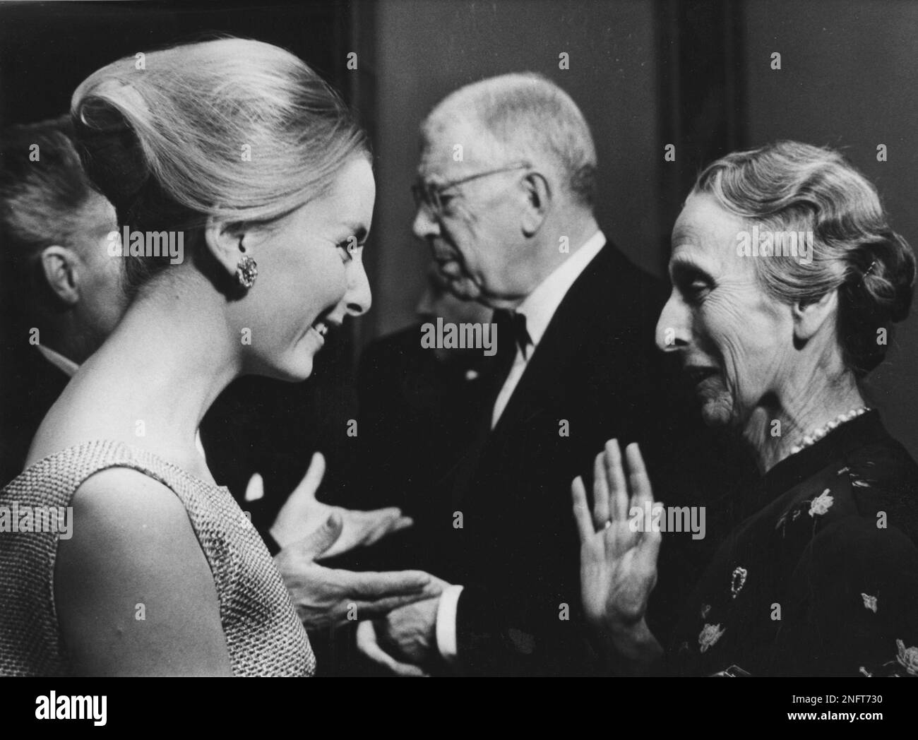 The King and Queen of Sweden speak with the wife of Austrian conductor Herbert von Karajan ...
