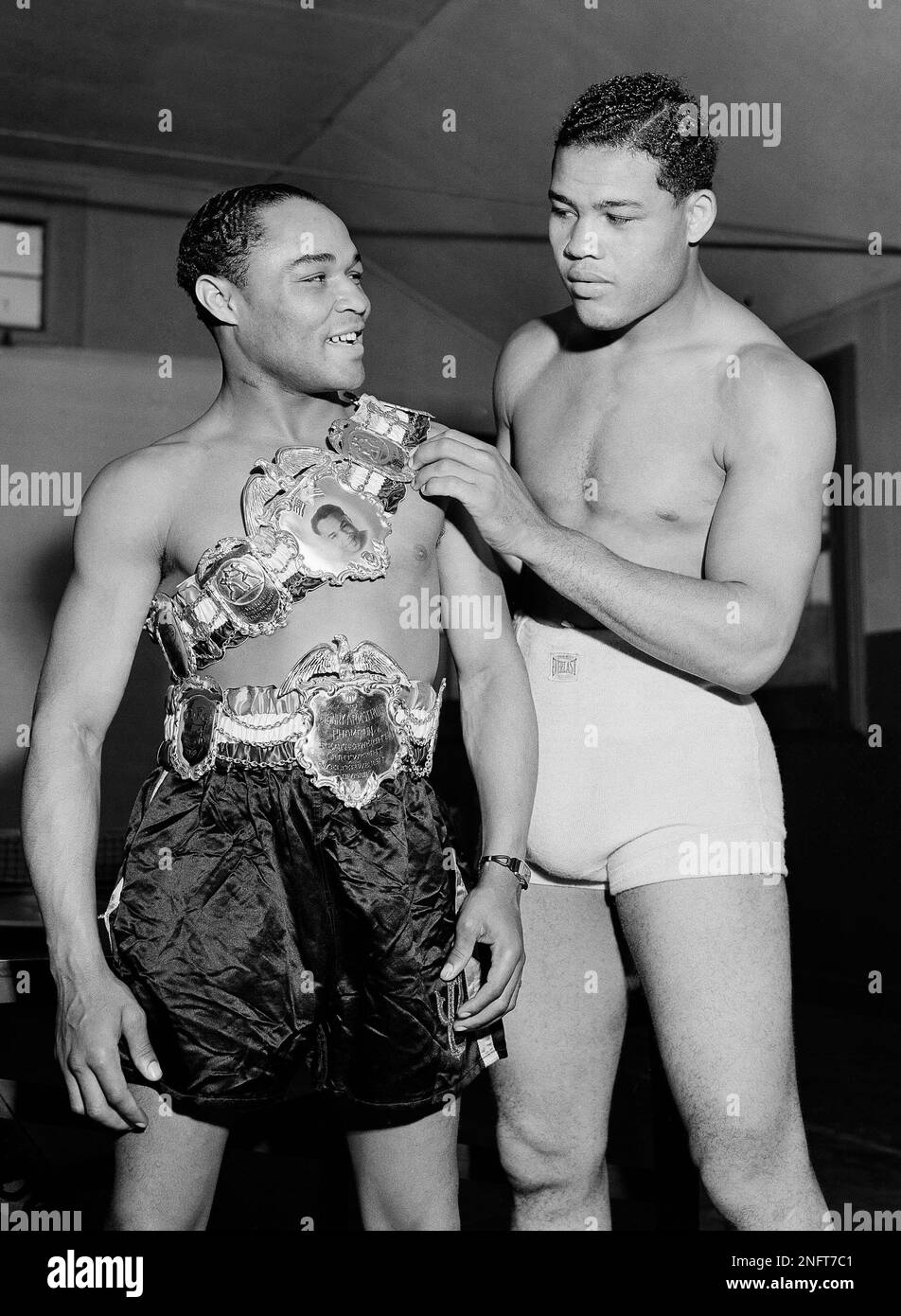 Joe Louis looks with envy on two awards that belong to Henry Armstrong ...