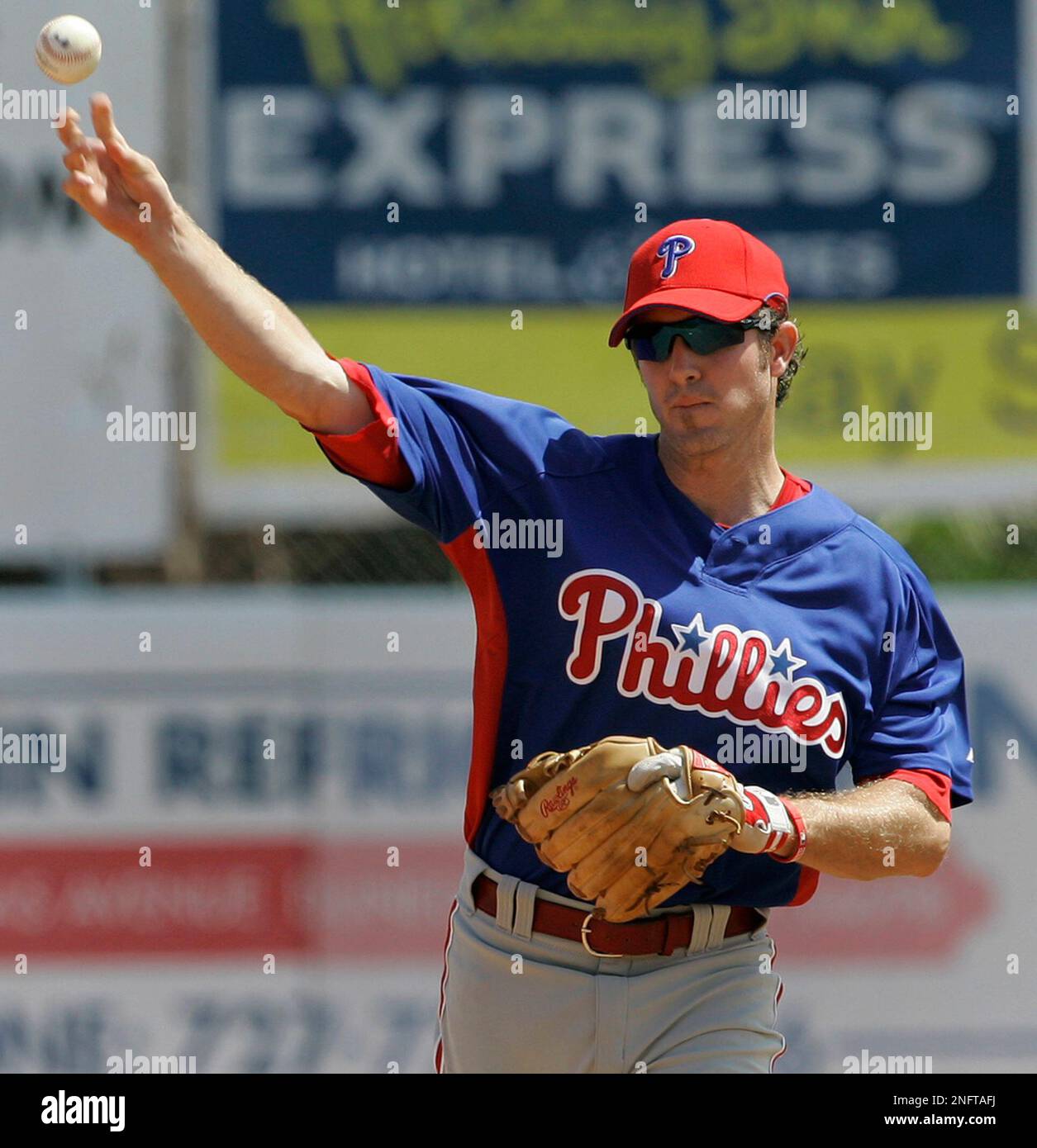 Philadelphia Phillies second baseman Chase Utley throws to first base ...