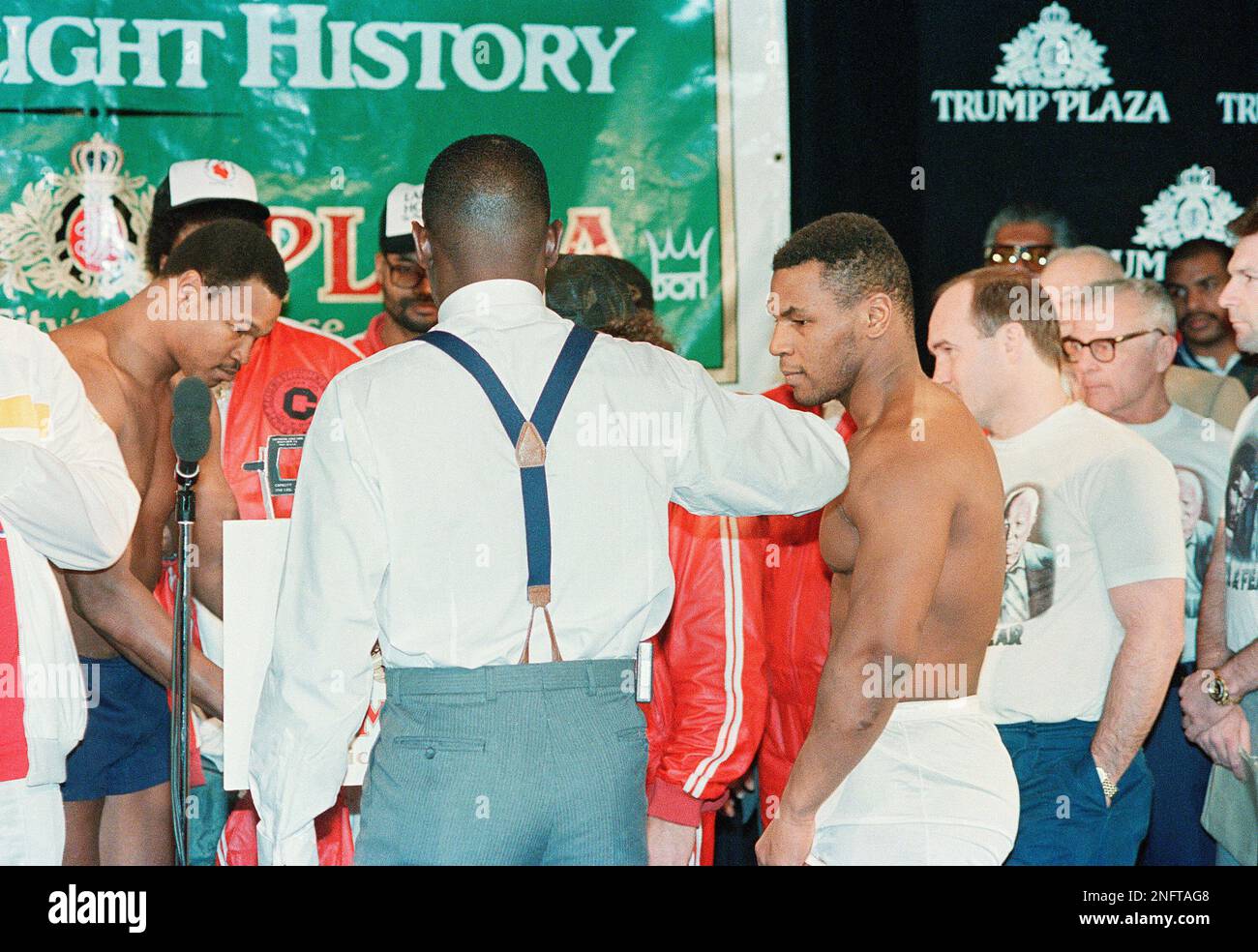 Heavyweights Larry Holmes, at left and Mike Tyson are shown passing ...